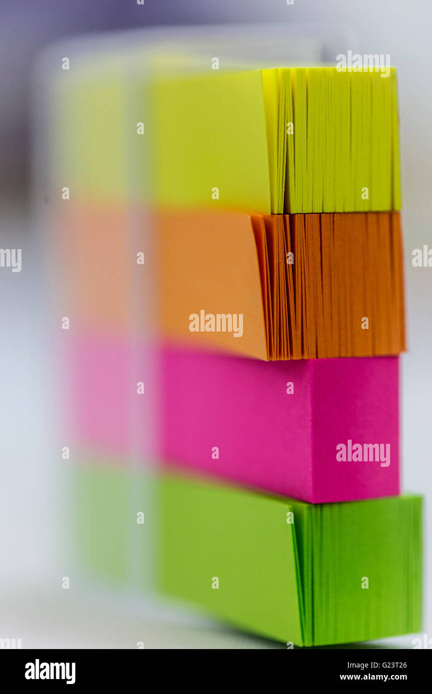 Coloured memo tags in a plastic container standing vertically Stock ...