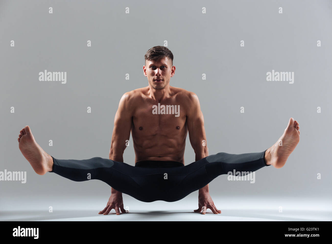 Fitness man doing yoga exercise isolated on a white background Stock ...