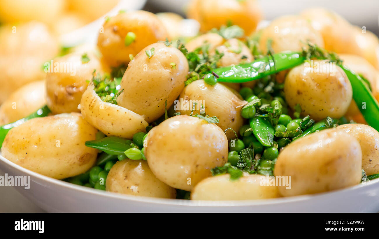 Hot buttered baby new potatoes in herbs Stock Photo - Alamy