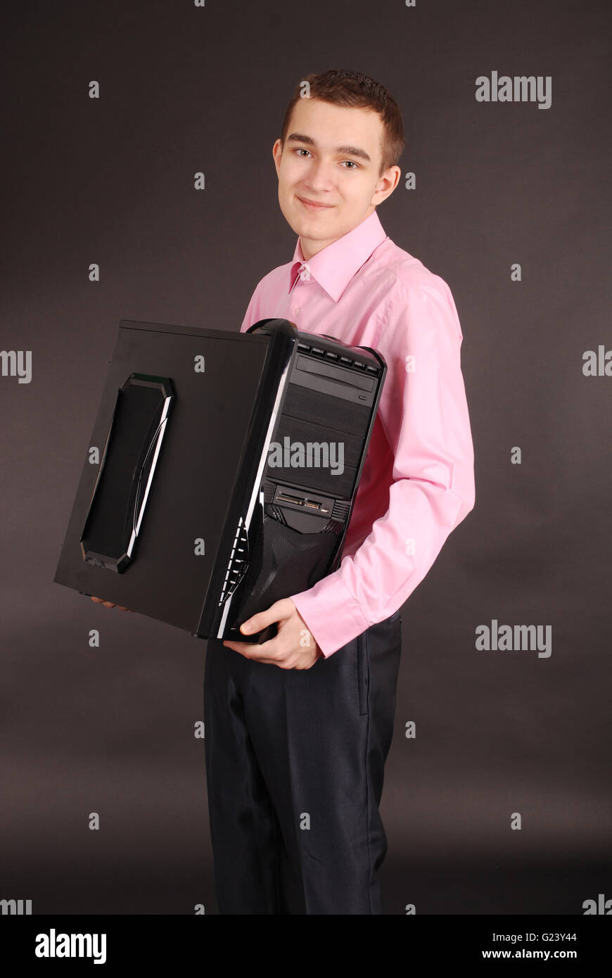 Young man holding a pc black background with soft shadow Stock Photo ...