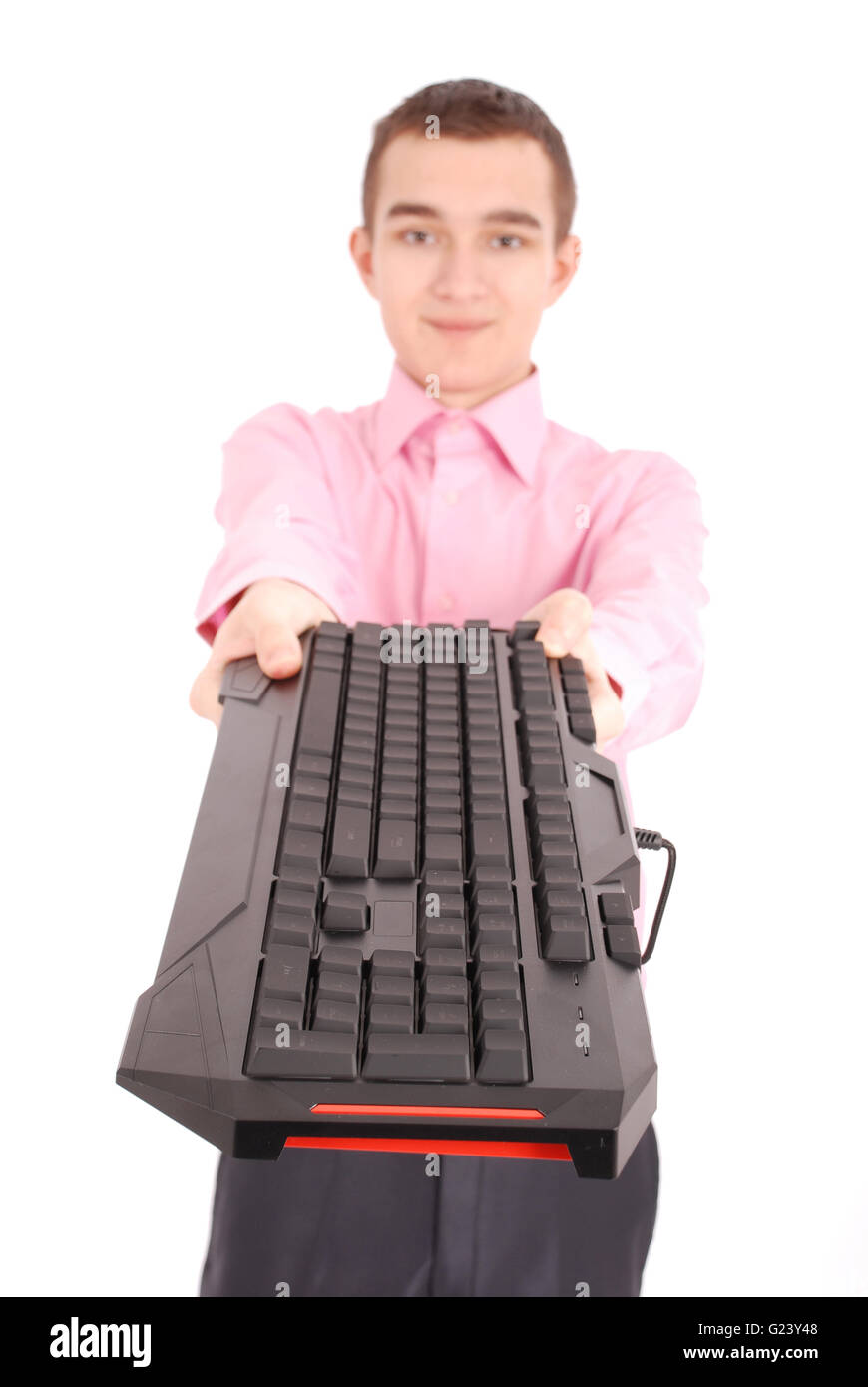 Smiling teenage boy with computer keyboard isolated on white background ...