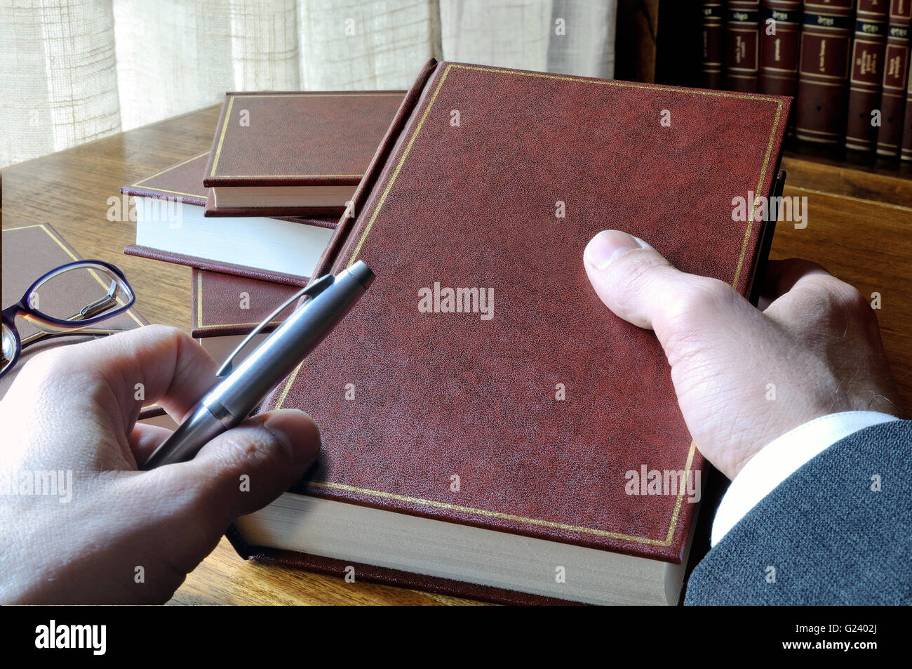 man who will take notes from a book, with window and library background ...