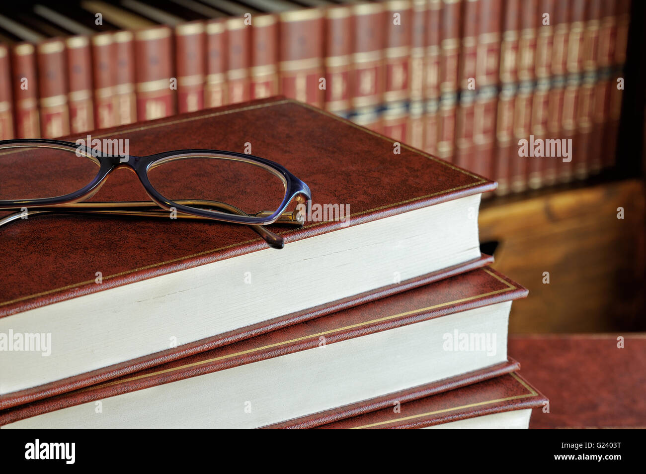stack of books and glasses detail with the bottom shelf Stock Photo - Alamy