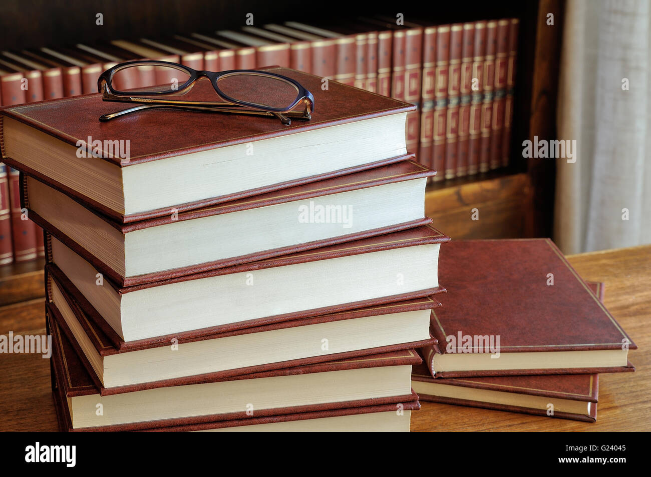 stack of books on the table and the bottom shelf Stock Photo - Alamy