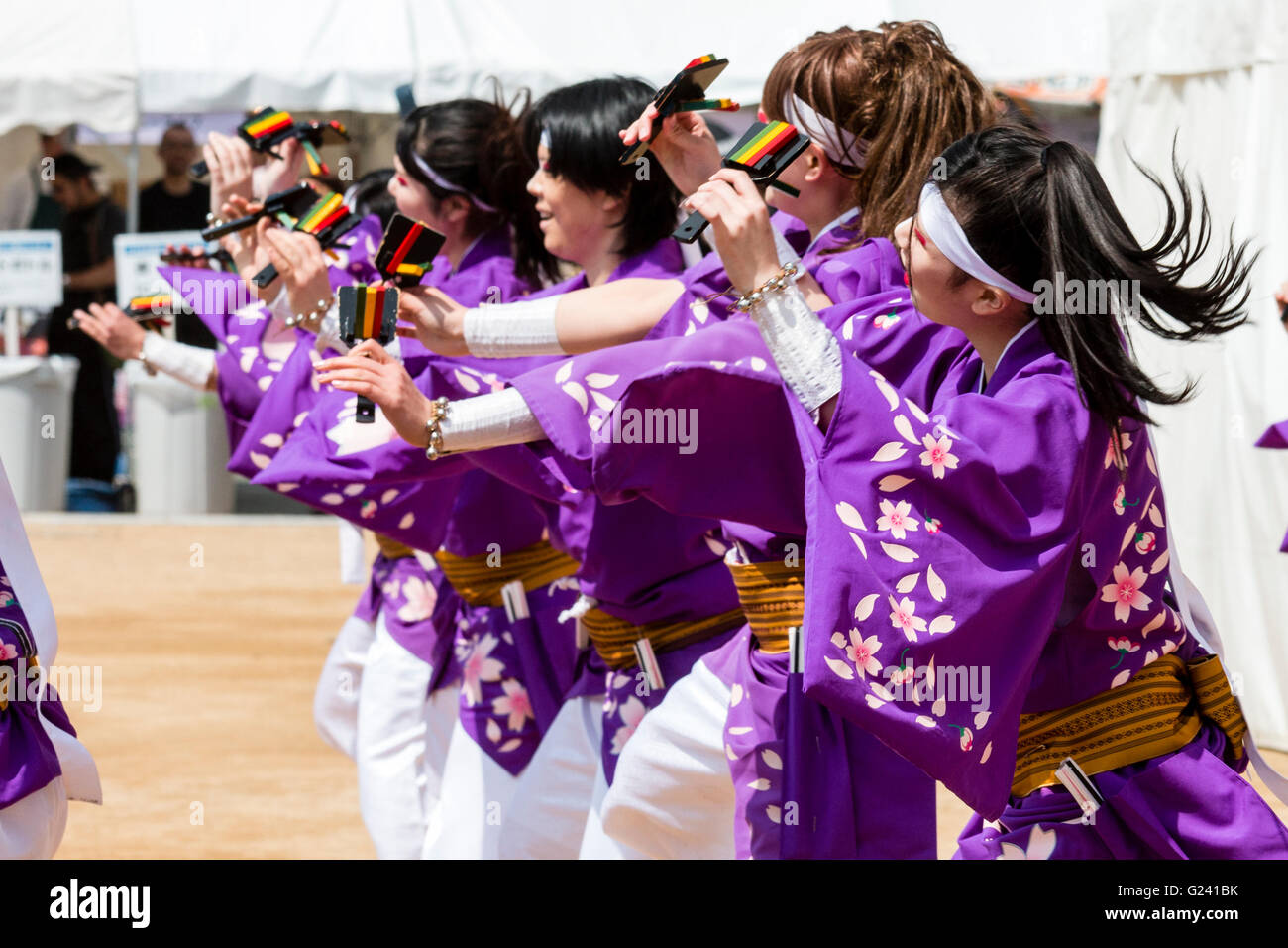 Japanese Hinokuni Yosakoi dance festival. Young women dancers in mauve ...