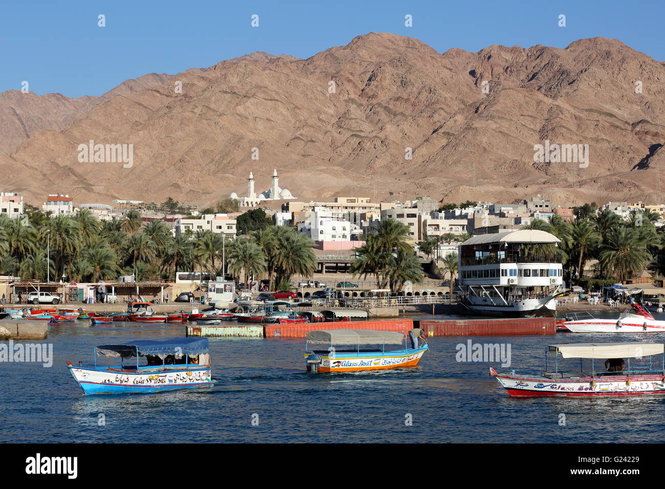 General view of the town of Aqaba in Jordan , glass boats in foreground ...