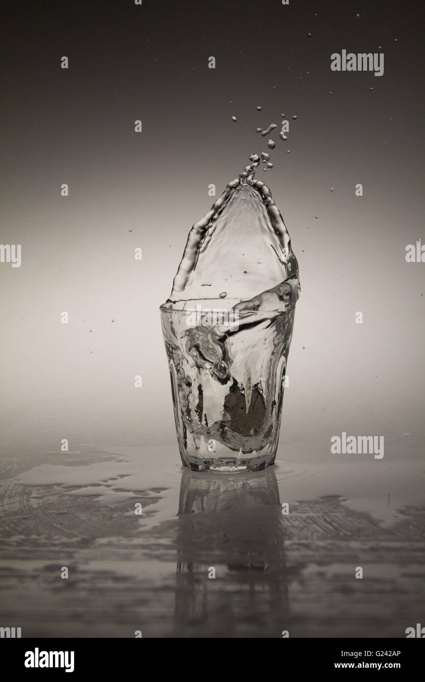 An image of water splashing out of a cup Stock Photo - Alamy