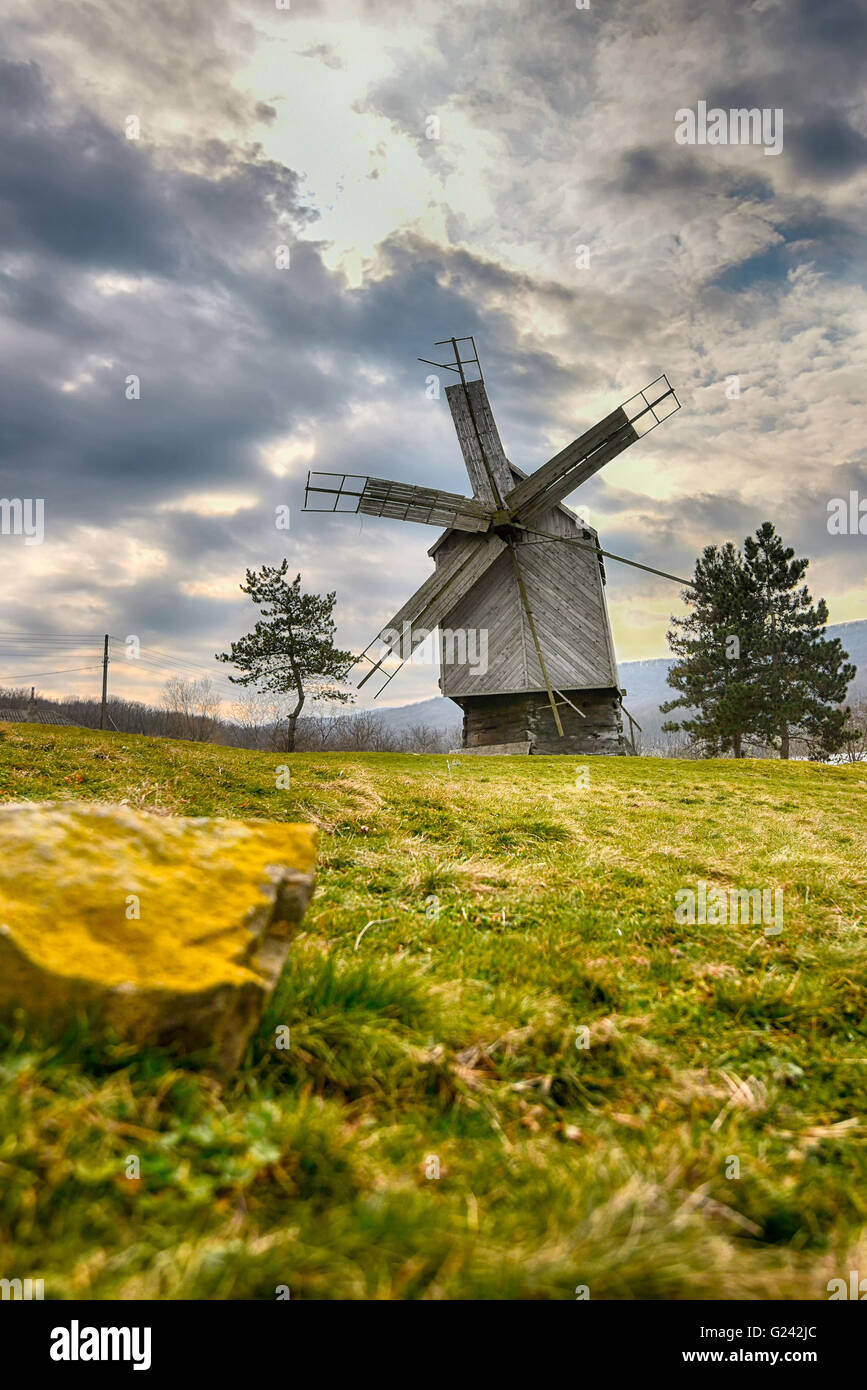 Wood windmill with grass and dramatic sky Stock Photo - Alamy