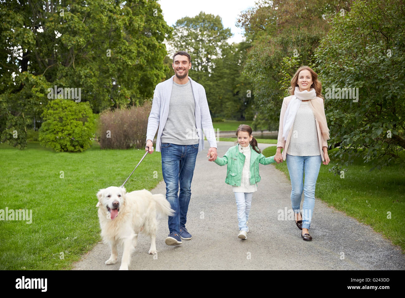 happy family with labrador retriever dog in park Stock Photo - Alamy