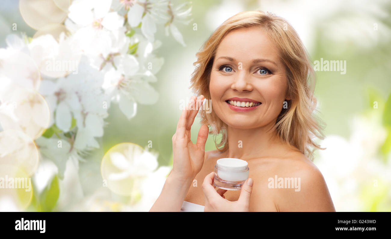 happy woman applying cream to her face Stock Photo - Alamy