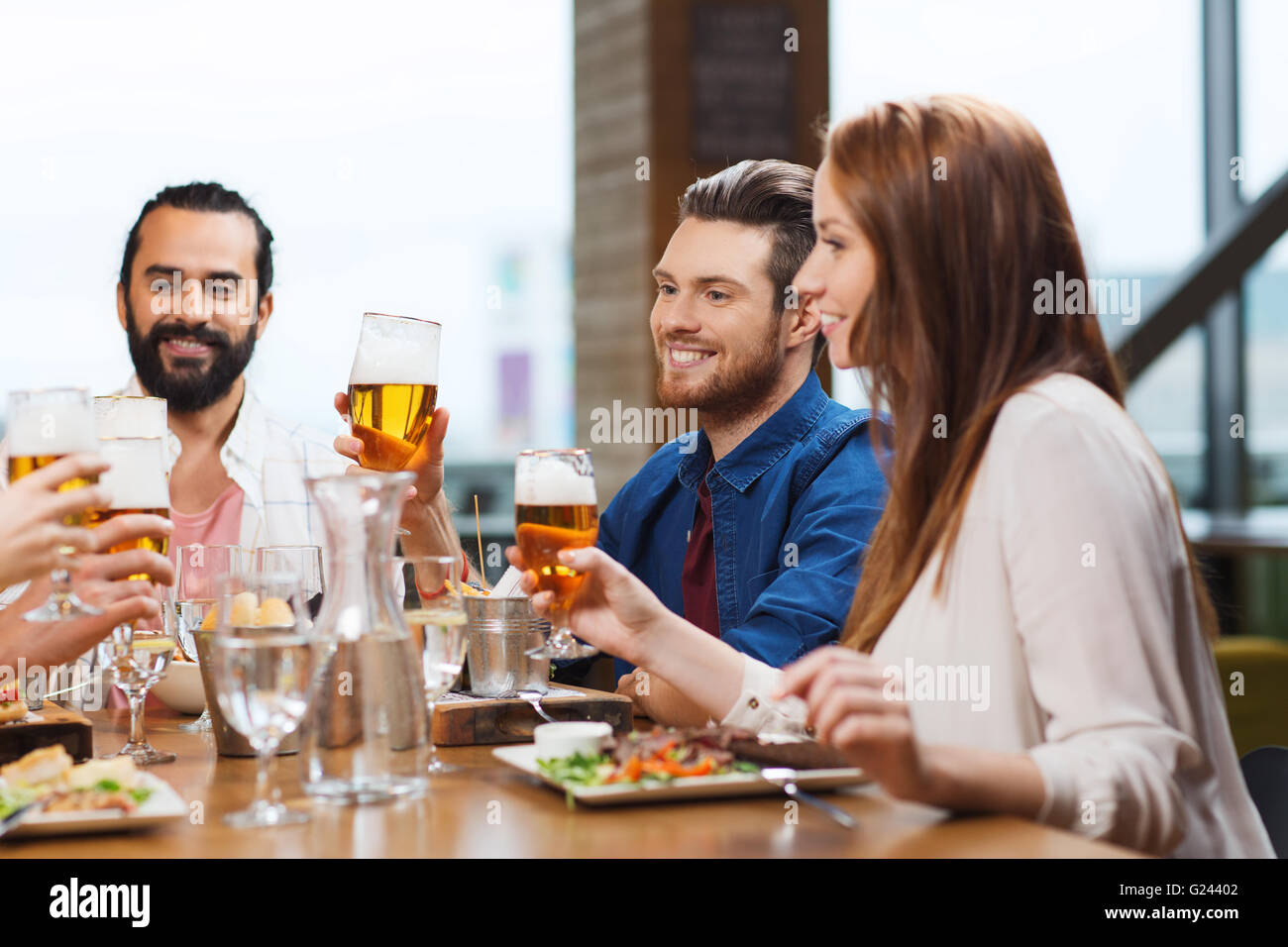 Happy friends restaurant dinner beer hi-res stock photography and ...