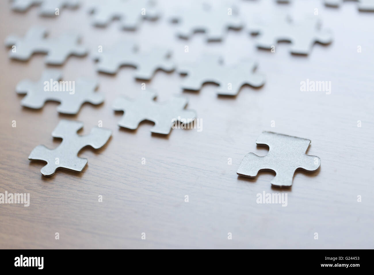 close up of puzzle pieces on wooden surface Stock Photo - Alamy