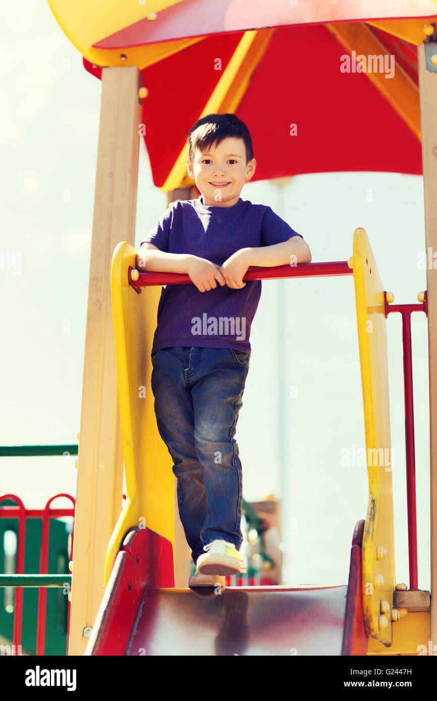 happy little boy climbing on children playground Stock Photo - Alamy