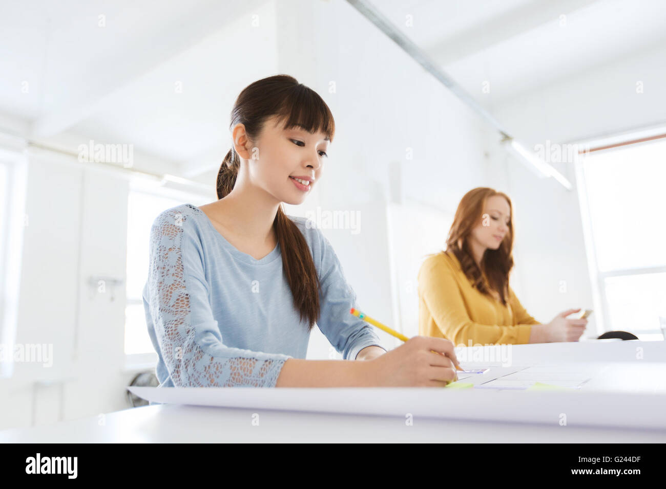 architect woman with blueprint writing at office Stock Photo - Alamy