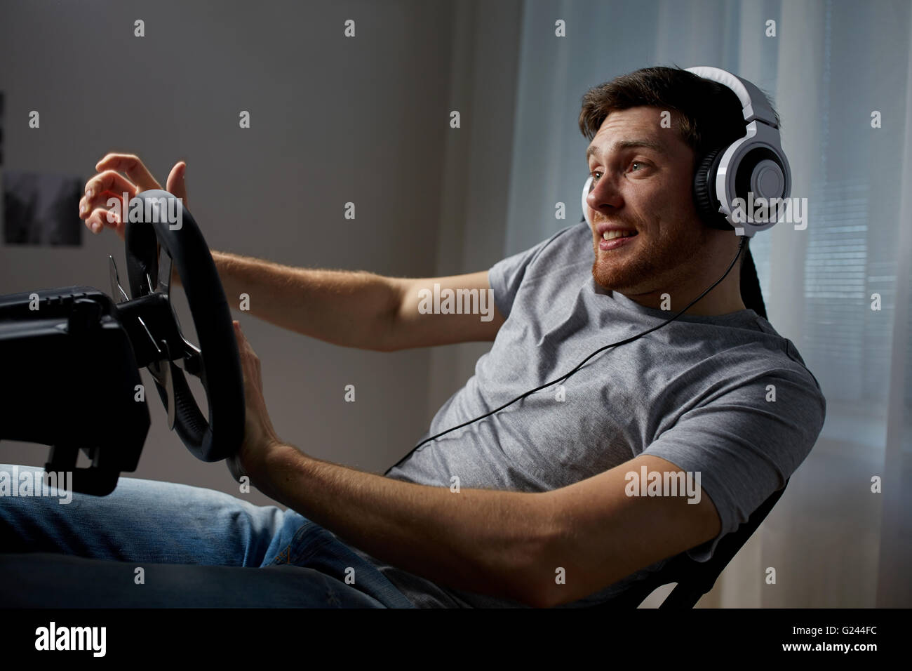 man playing car racing video game at home Stock Photo - Alamy