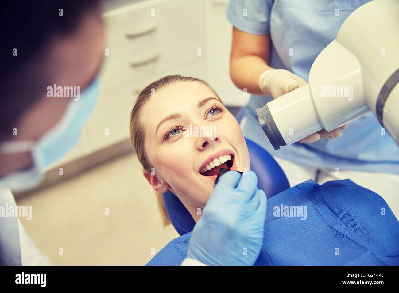 female patient face with x-ray machine and shield Stock Photo - Alamy