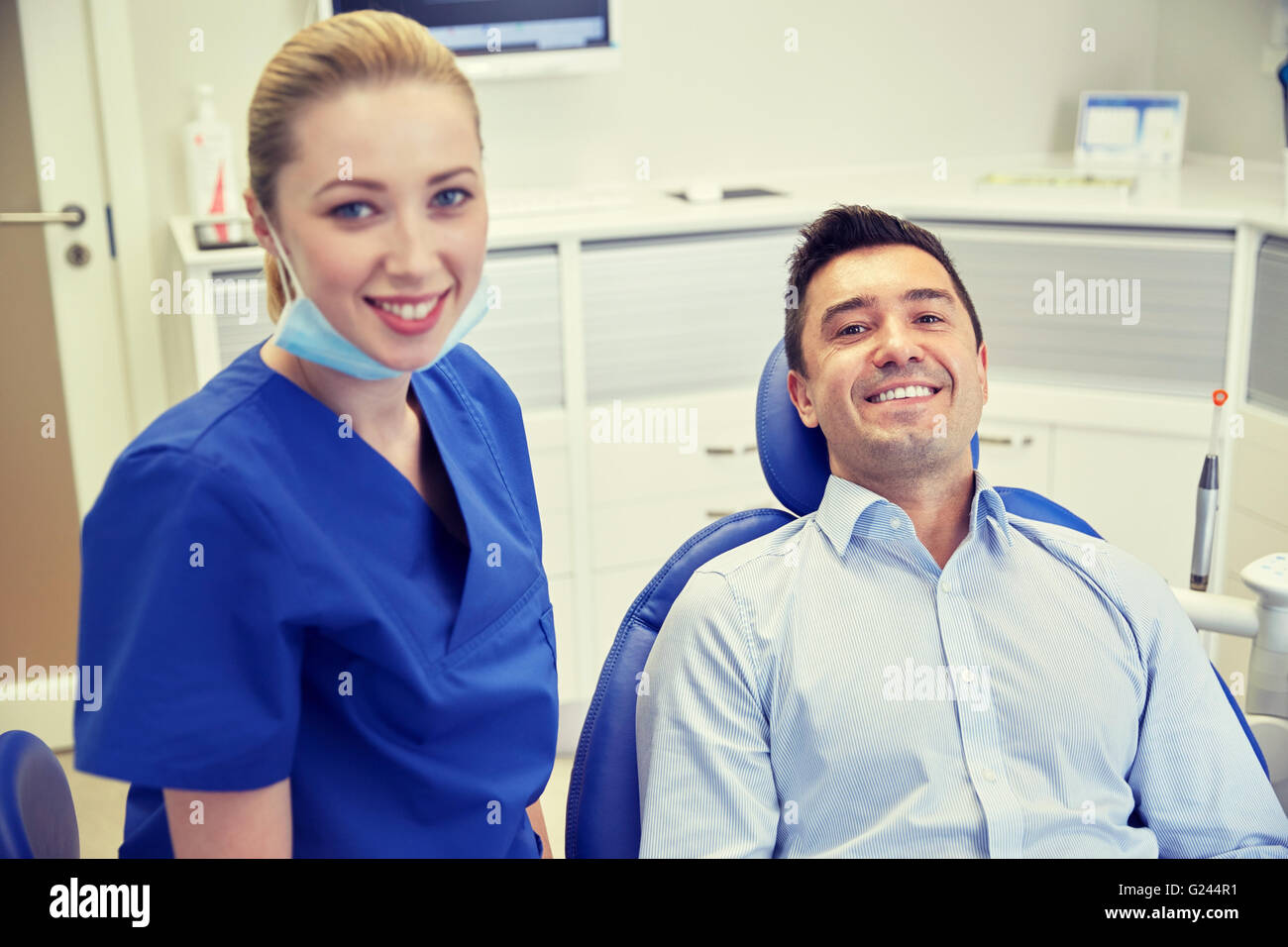 happy female dentist with man patient at clinic Stock Photo - Alamy