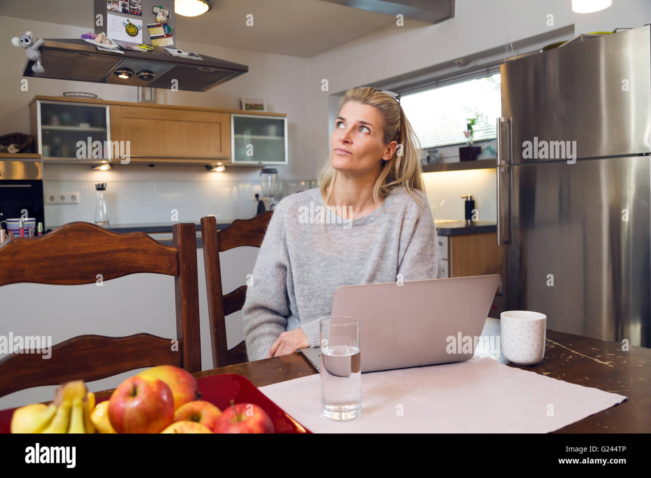 Work from home woman in a pensive state of mind Stock Photo - Alamy