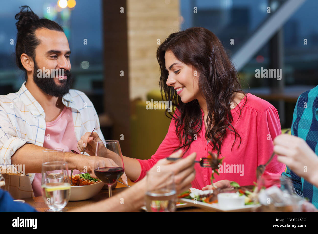 friends eating and tasting food at restaurant Stock Photo - Alamy