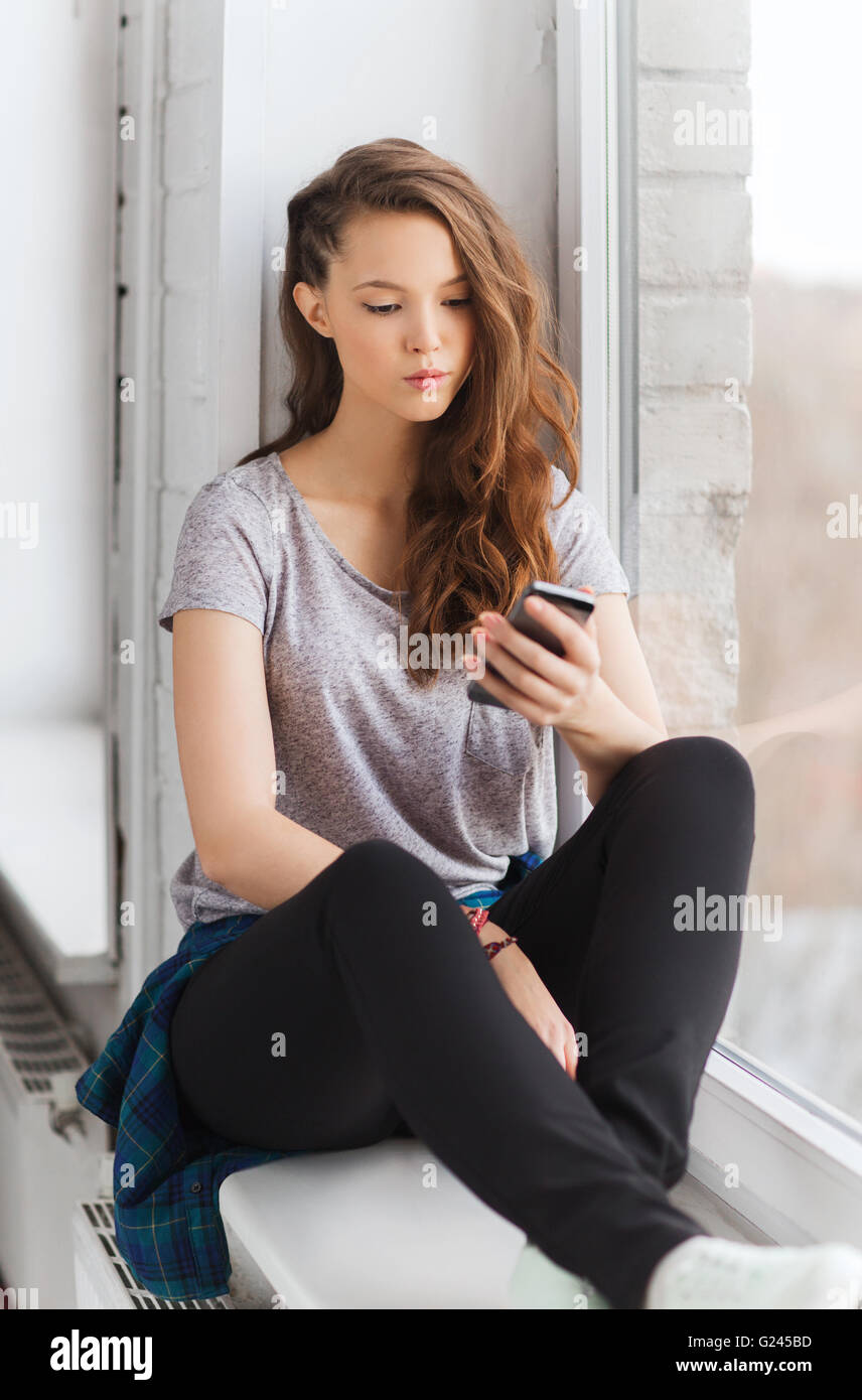 sad pretty teenage girl with smartphone texting Stock Photo - Alamy