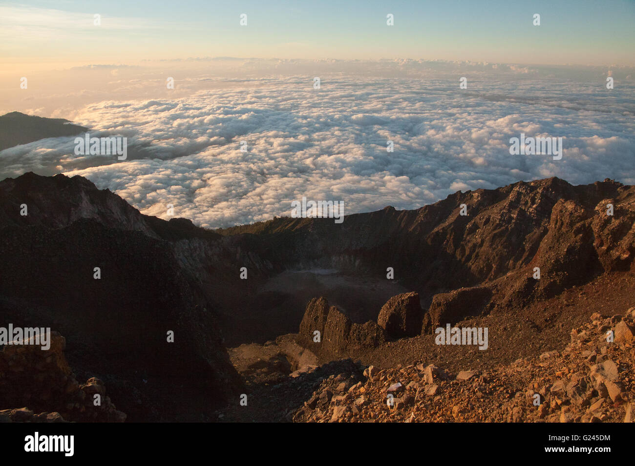 Enjoying sunrise view at summit top in high mountain volcano Rinjani ...