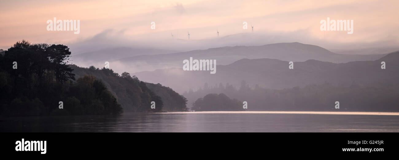 Sunset over Coniston Water with wind turbines on Kirkby moor in the ...