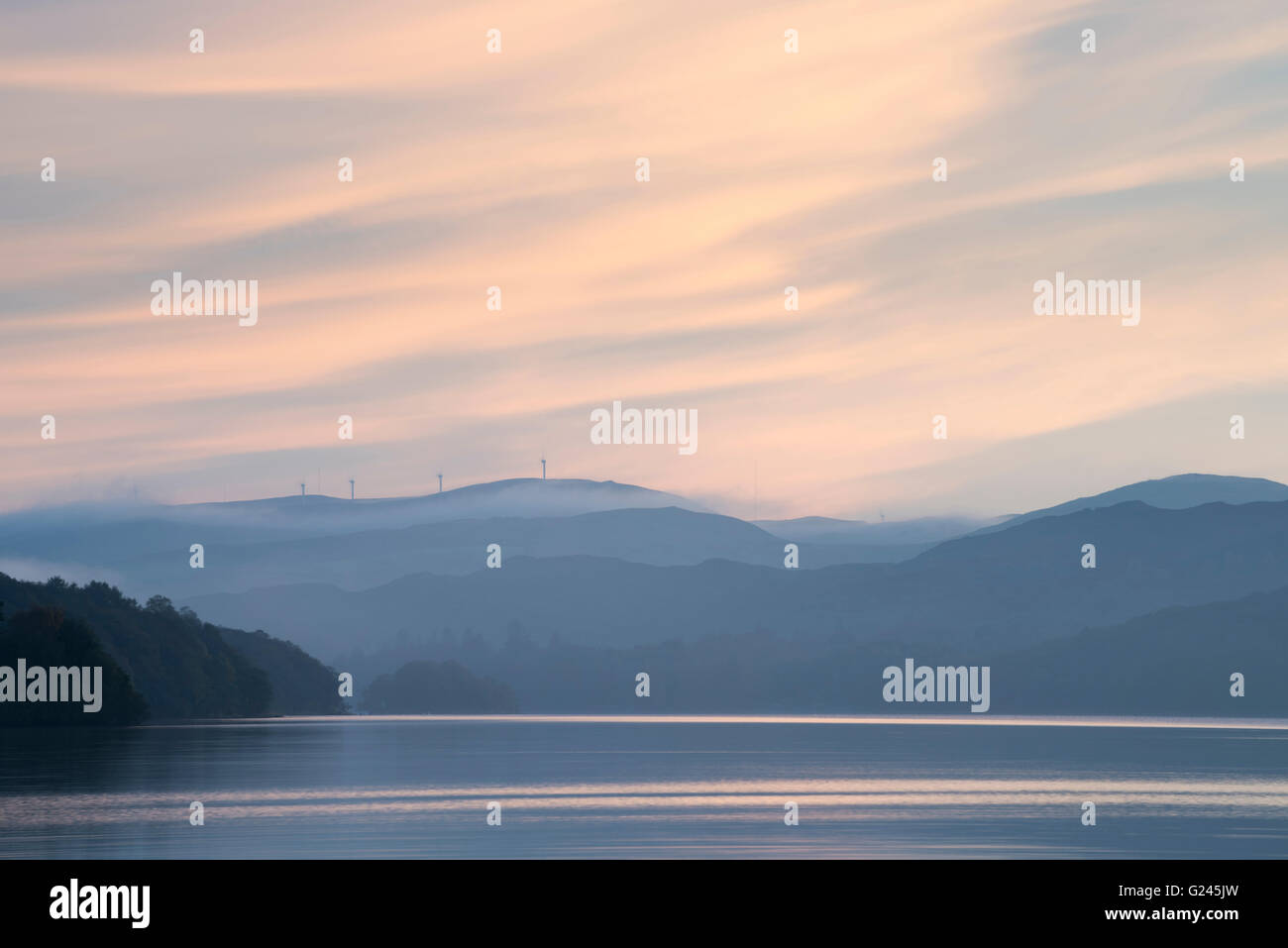 Sunset over Coniston Water with wind turbines on Kirkby moor in the ...