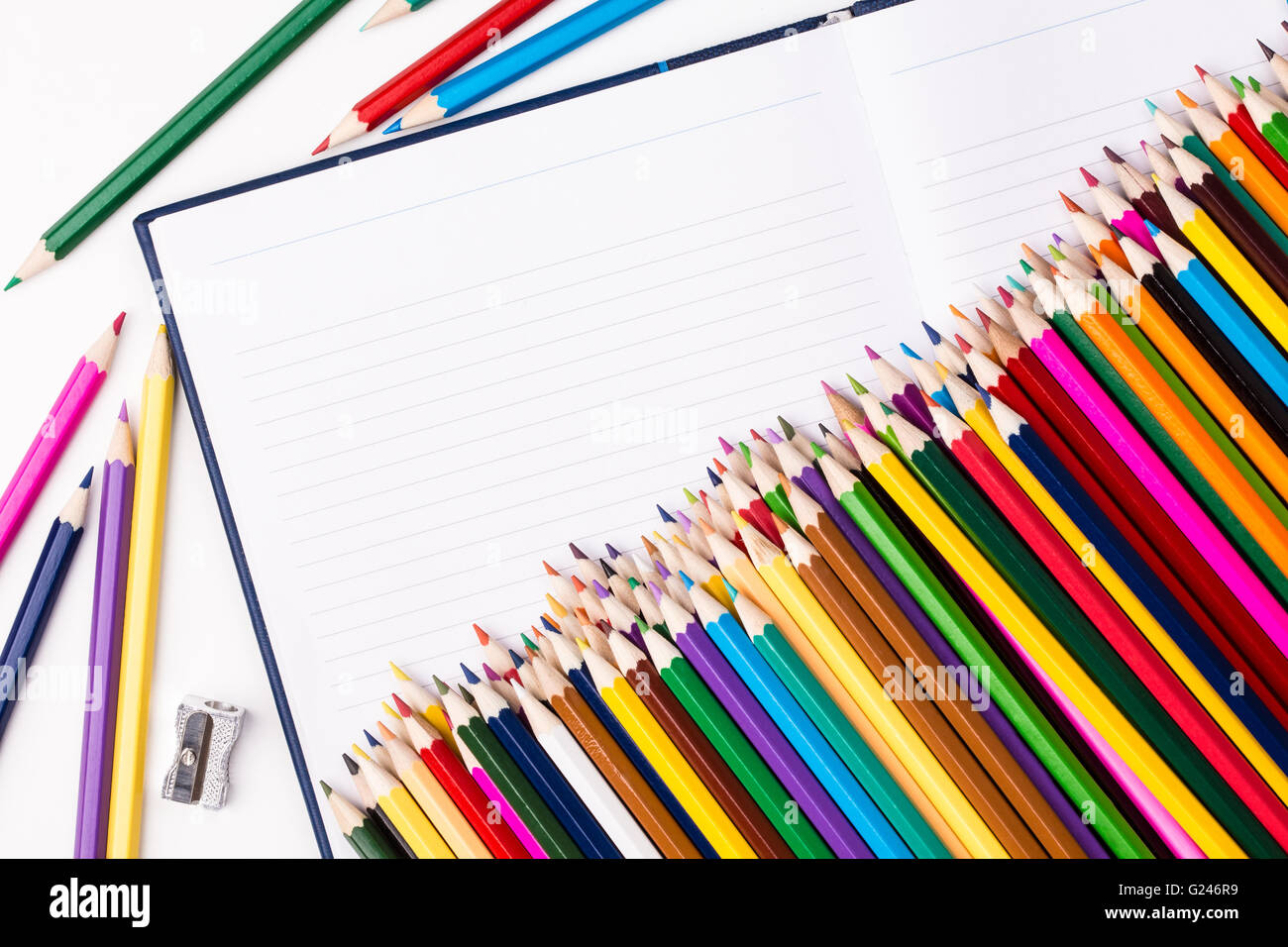 Bunch of color pencils on an open notebook with copy space Stock Photo ...