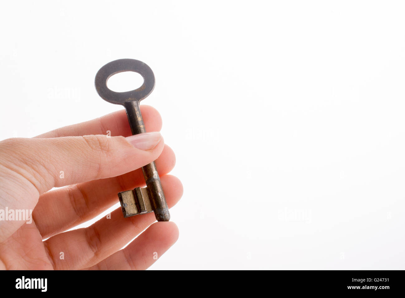 Hand holding a key on a white background Stock Photo - Alamy