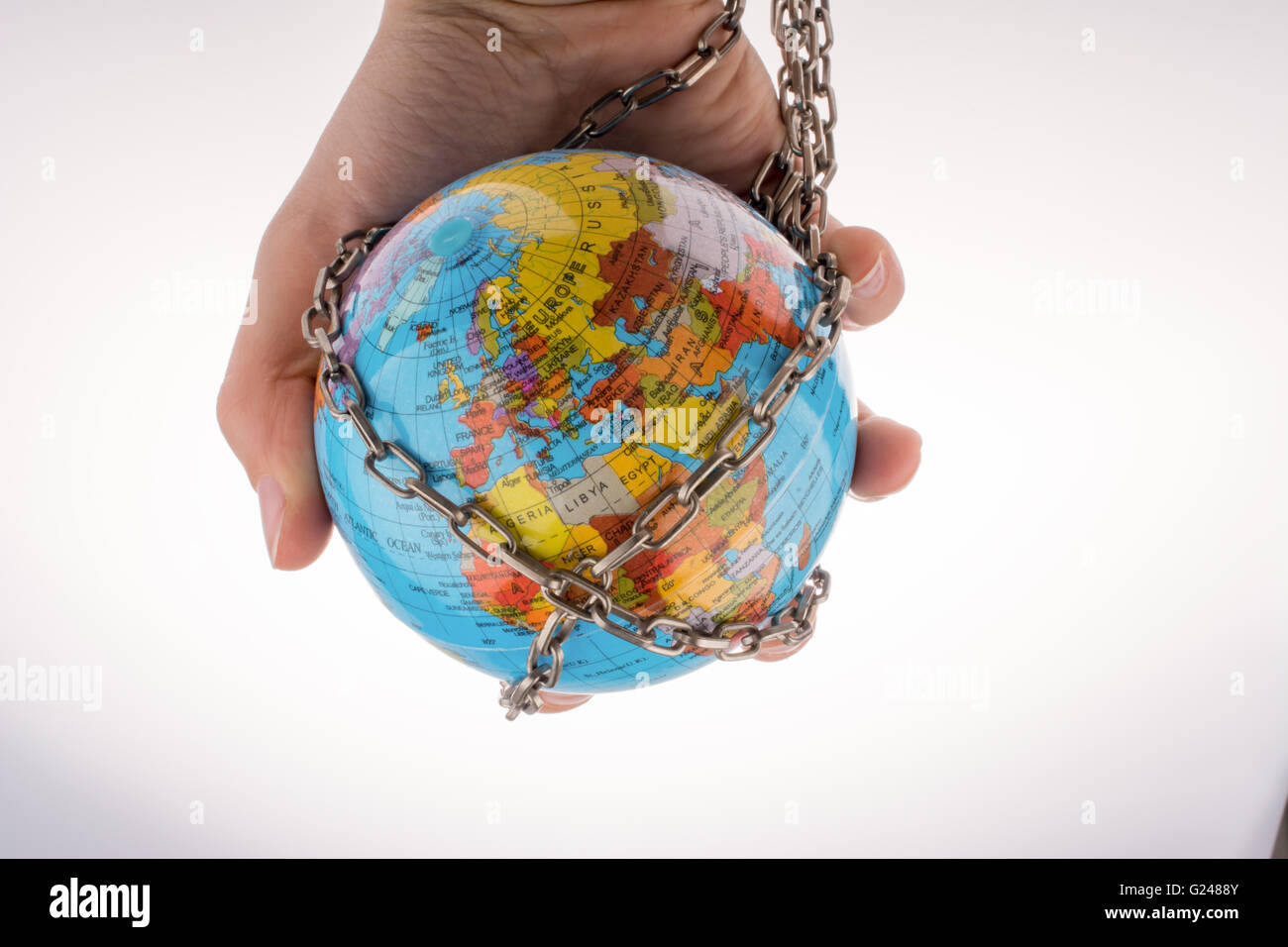 Globe in chain on a white background Stock Photo - Alamy