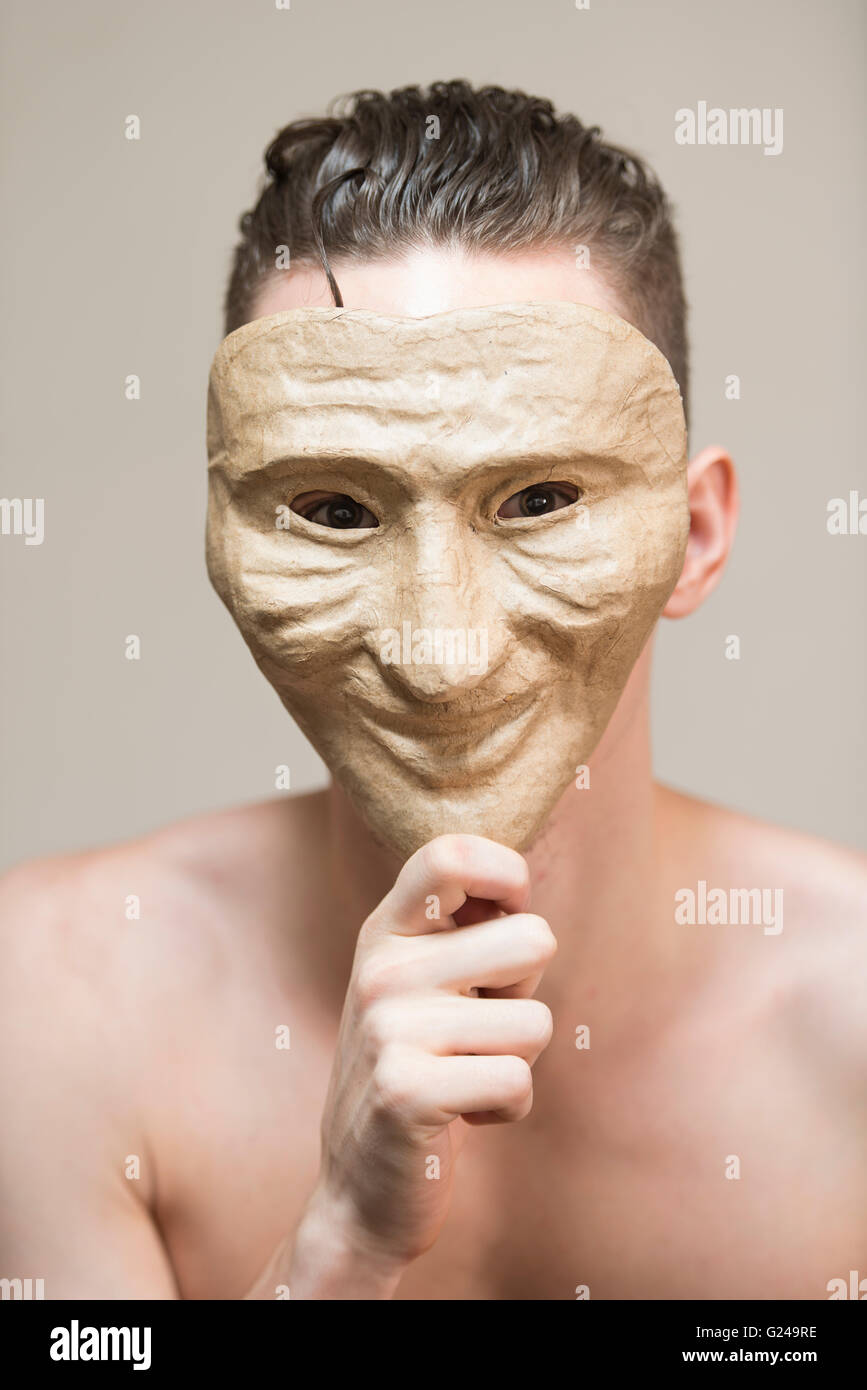 Man hiding behind a happy mask Stock Photo - Alamy Man hiding behind a happy mask Stock Photo - Alamy
