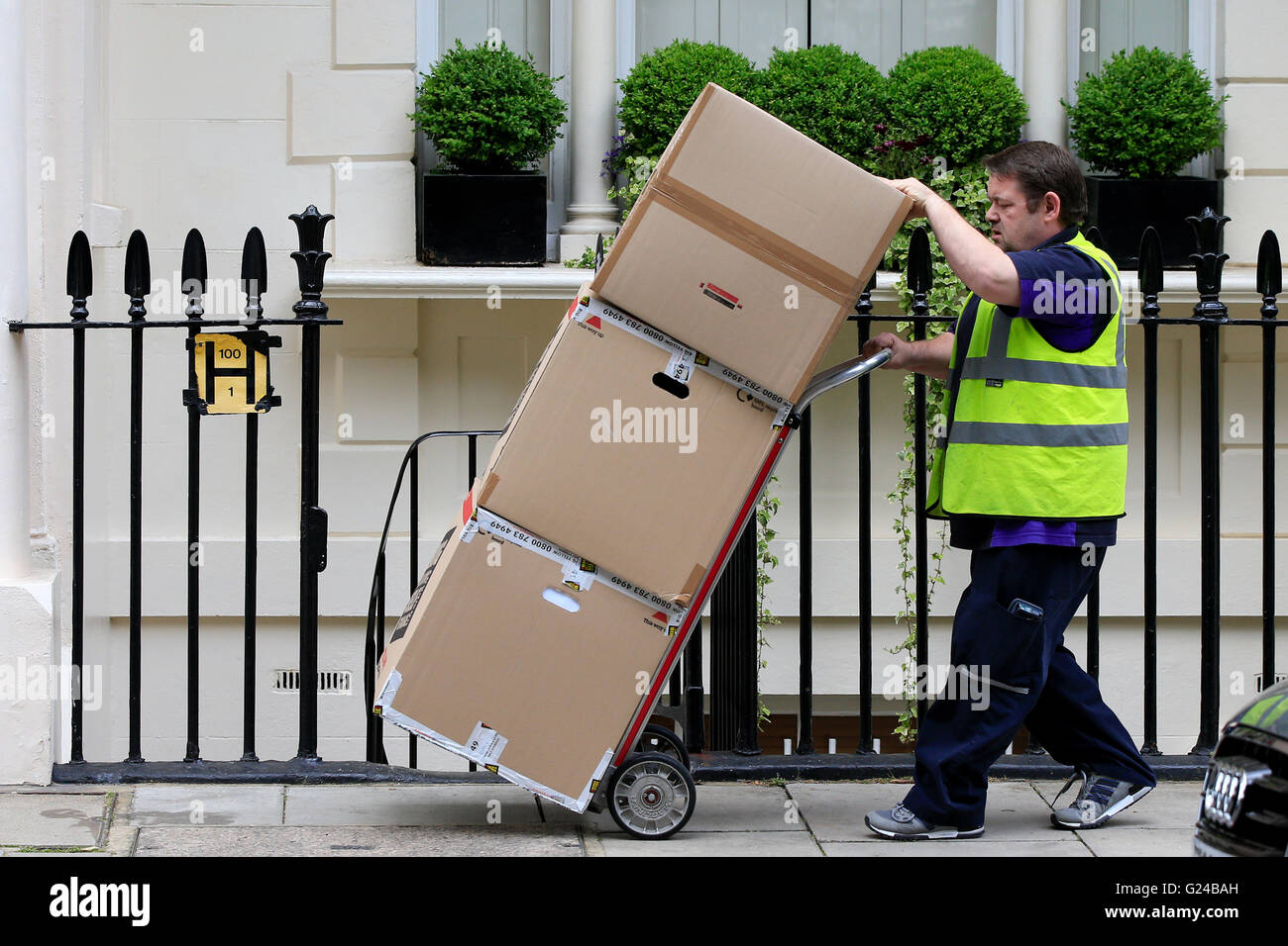 Removal men carry boxes out of Jose Mourinho's London house this ...