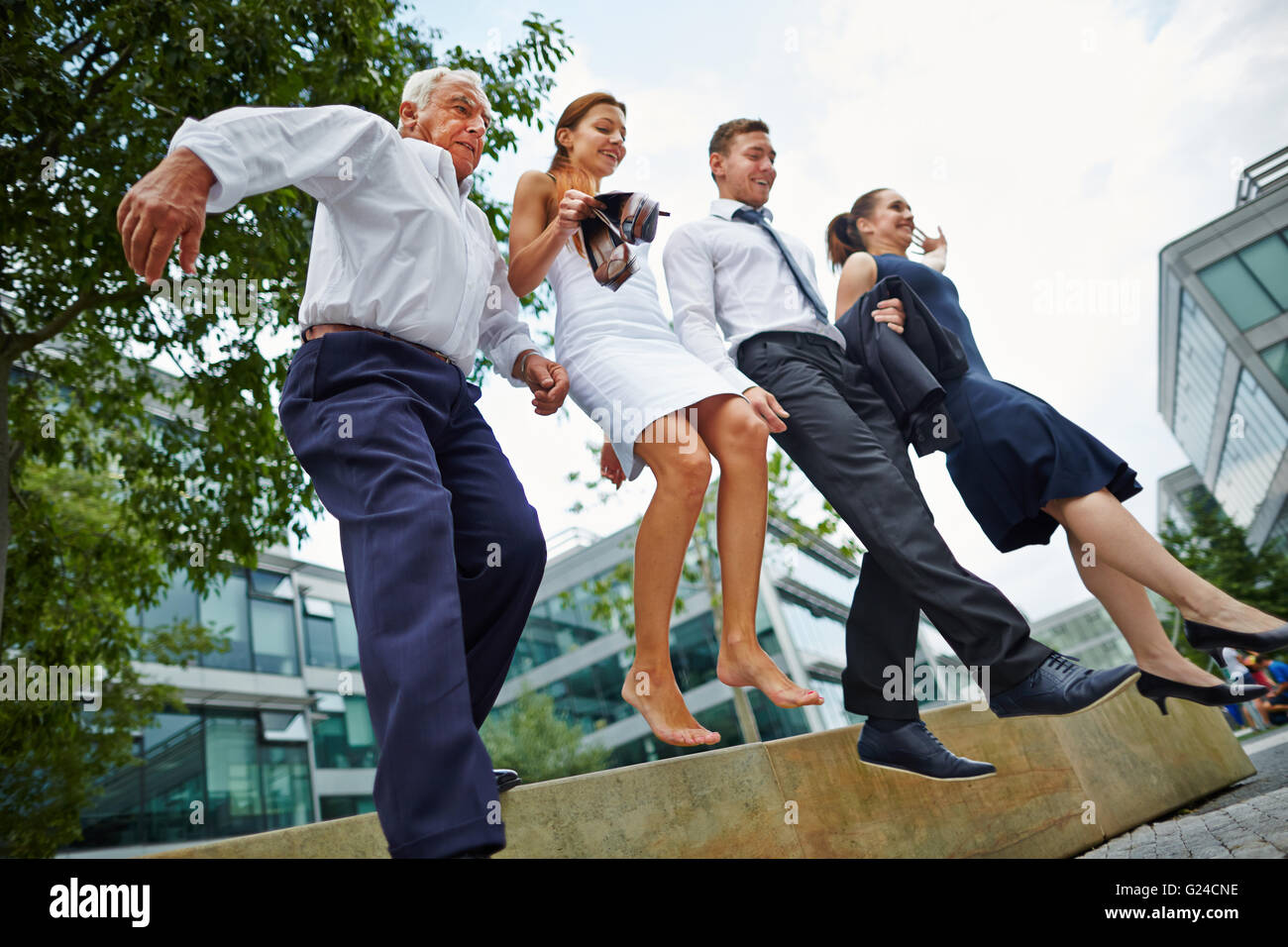 Group of business people jumping together over obstacle outdoors Stock ...