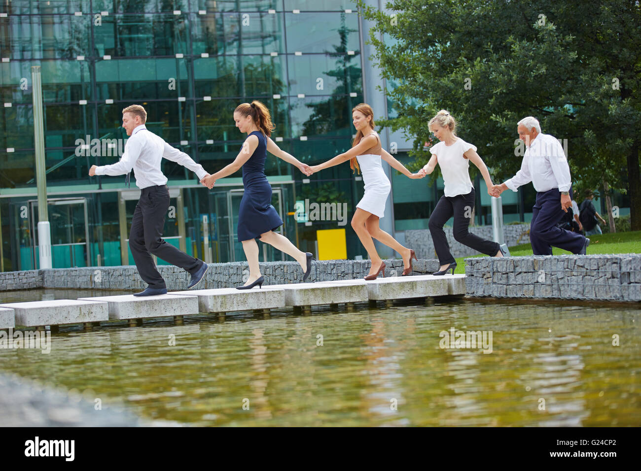 Business team forming network while running over a bridge Stock Photo ...