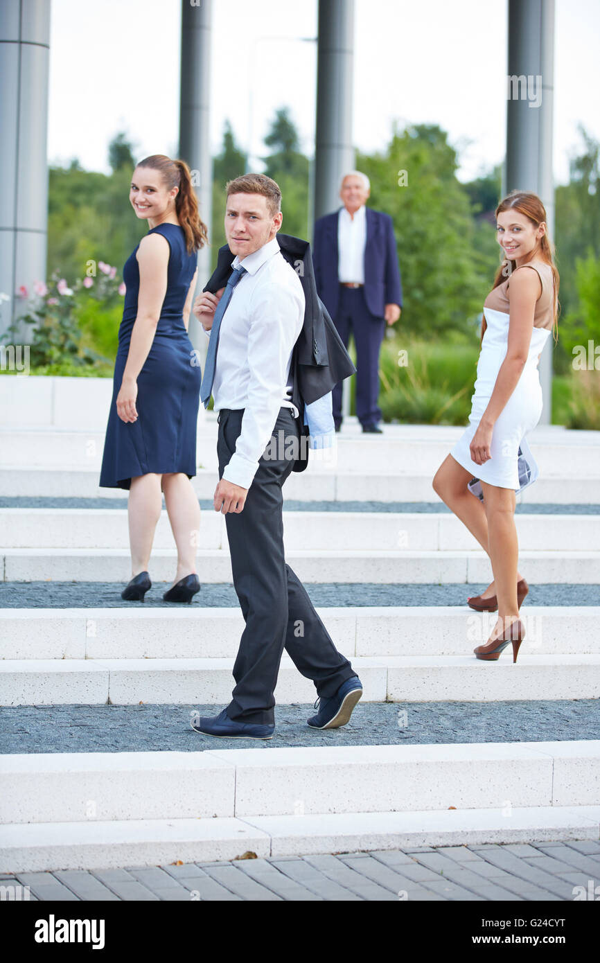 Many smiling business people turning around on stairs Stock Photo - Alamy