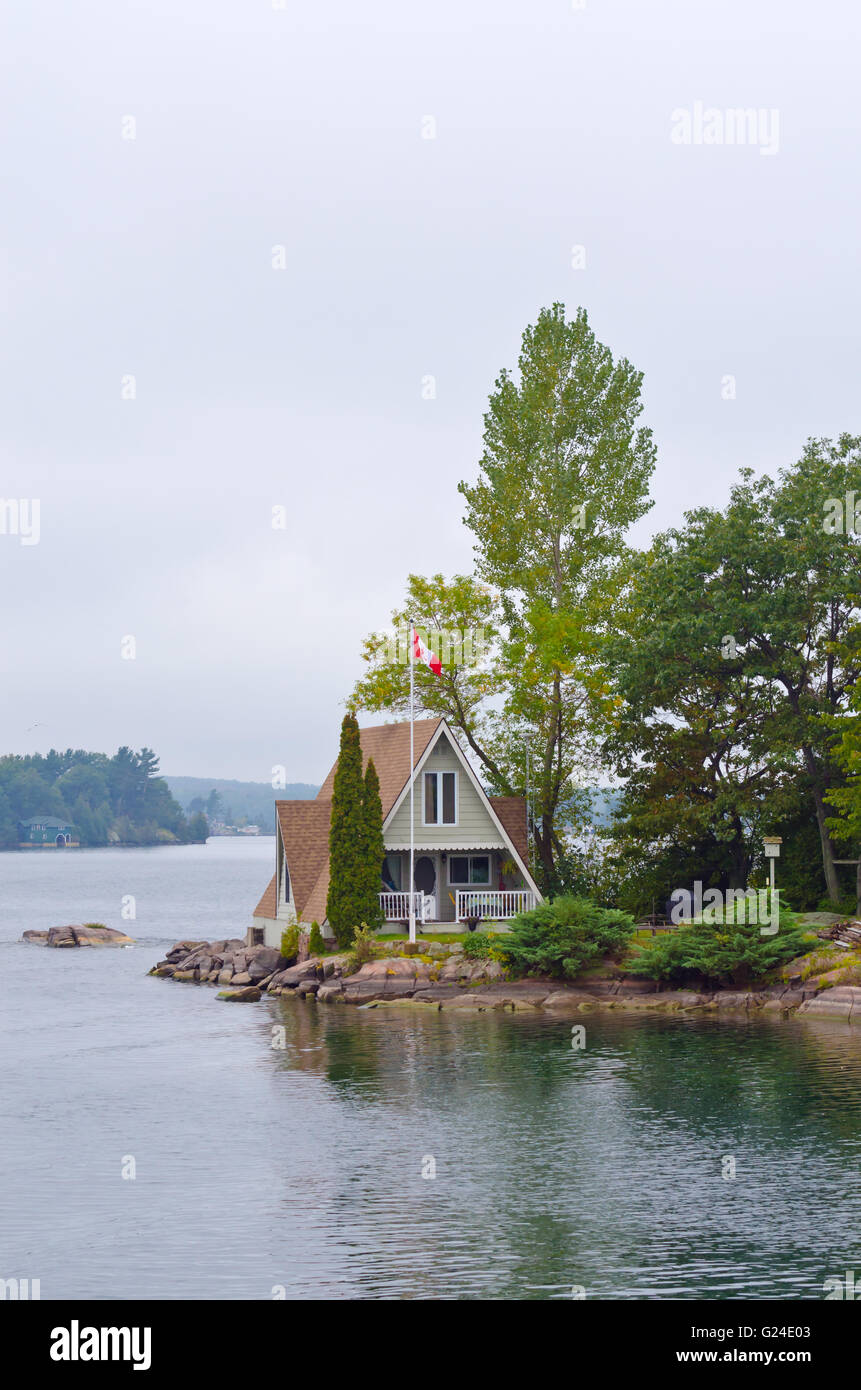 Lone cottage on stone small island Stock Photo - Alamy