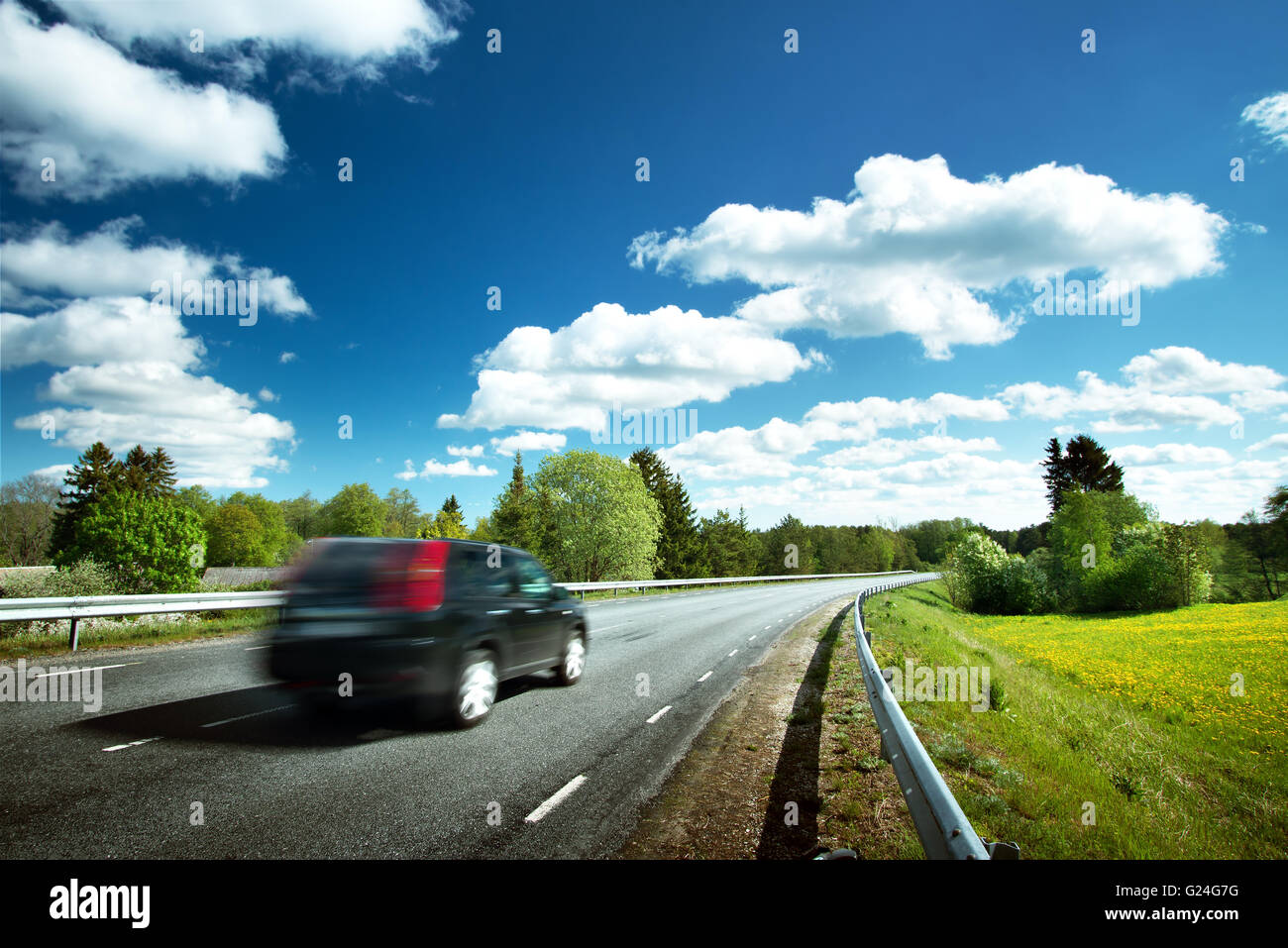 Car on asphalt road in beautiful spring day Stock Photo - Alamy