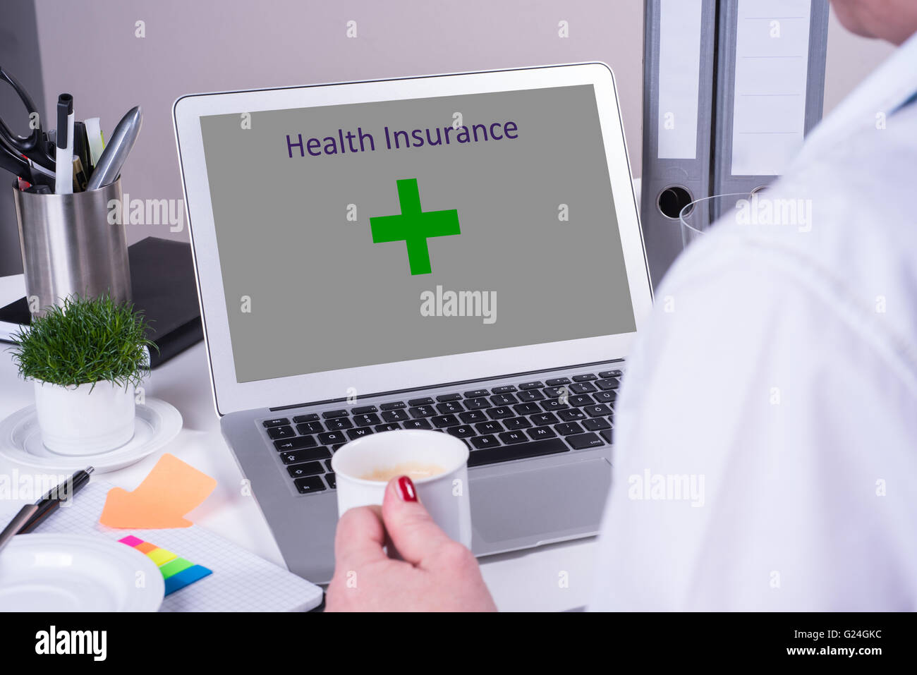 woman looking on computer with health insurance Stock Photo - Alamy