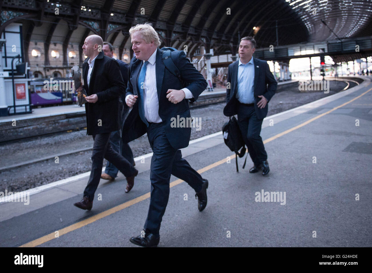 Former Mayor Boris Johnson (centre) runs for a train at York Railway ...