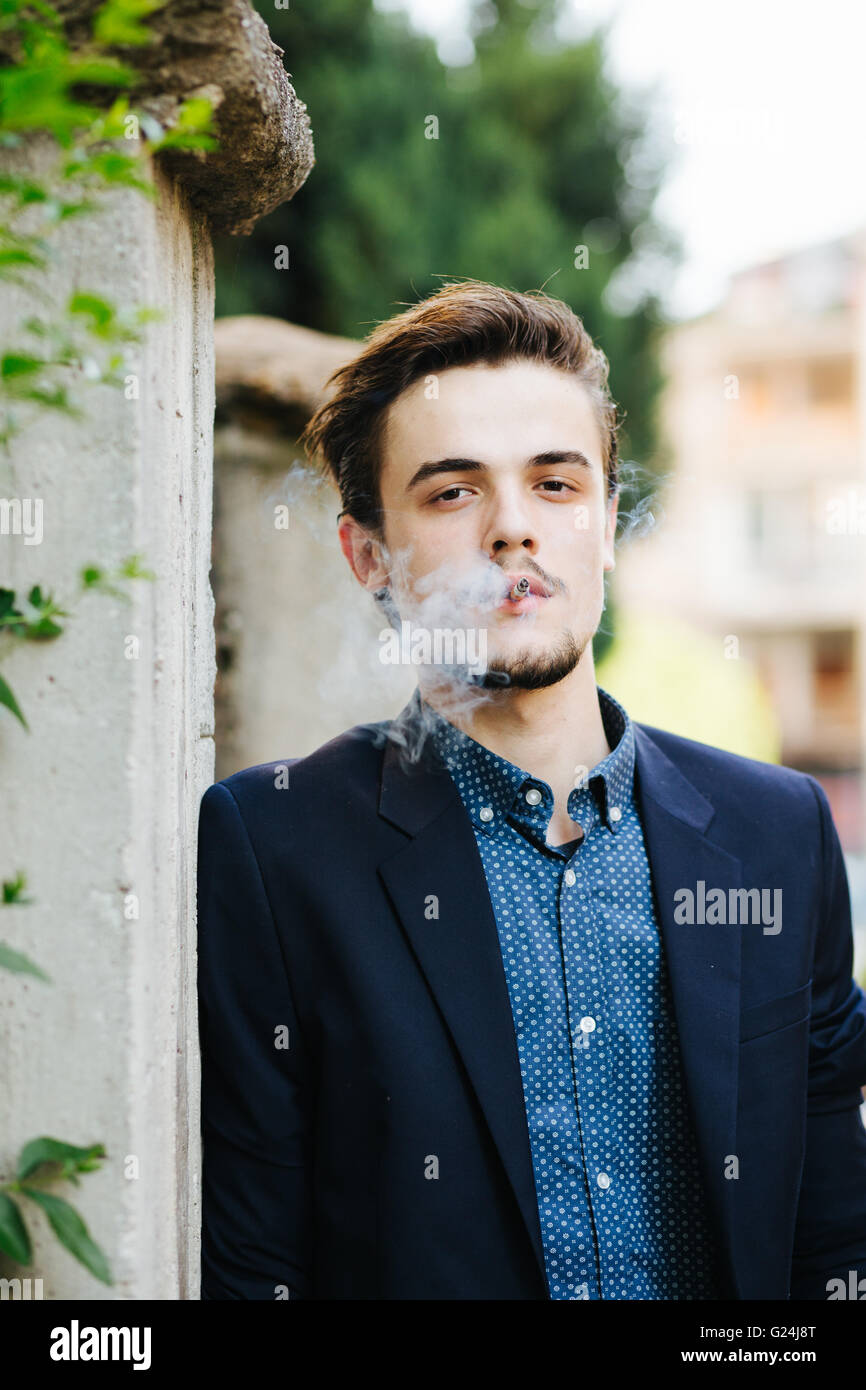 Portrait of a young man smoking Stock Photo - Alamy
