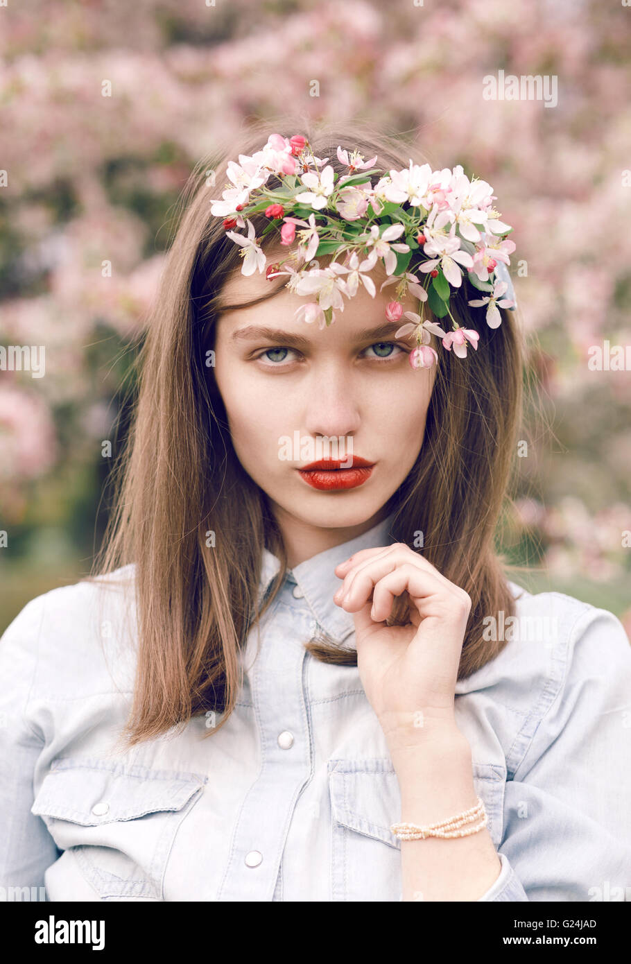 Portrait of a young woman spring flowers in her hair Stock Photo - Alamy