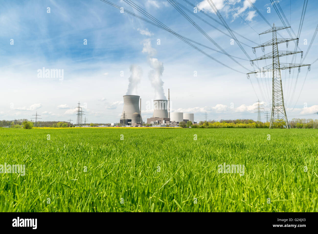 Nuclear power plant with green field and big blue clouds Stock Photo ...
