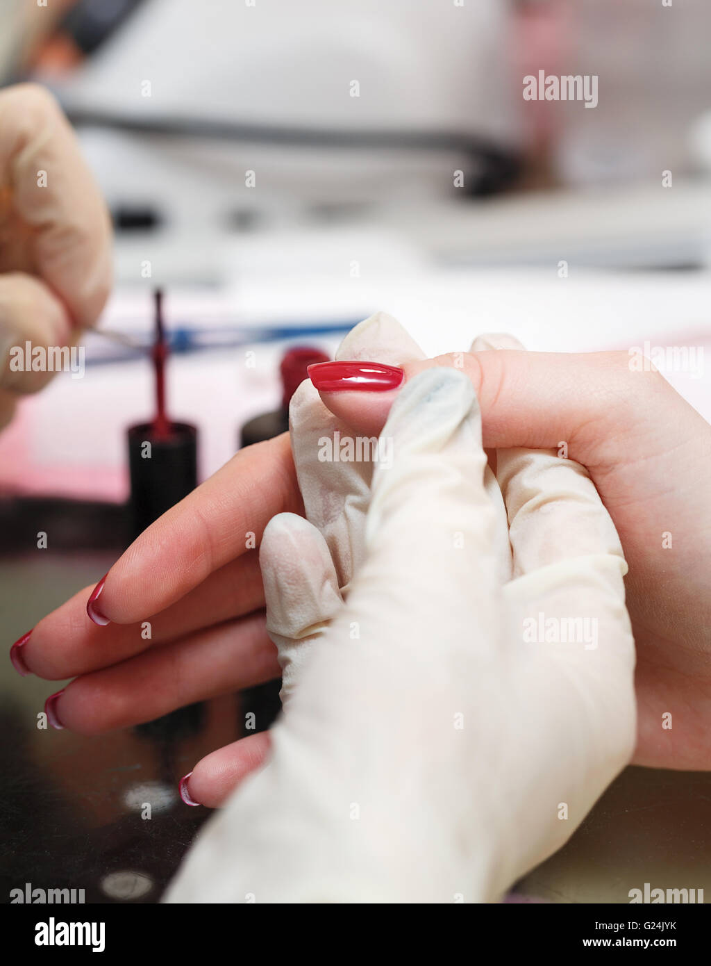 Covering nail varnish color close-up in a beauty salon. Manicure ...