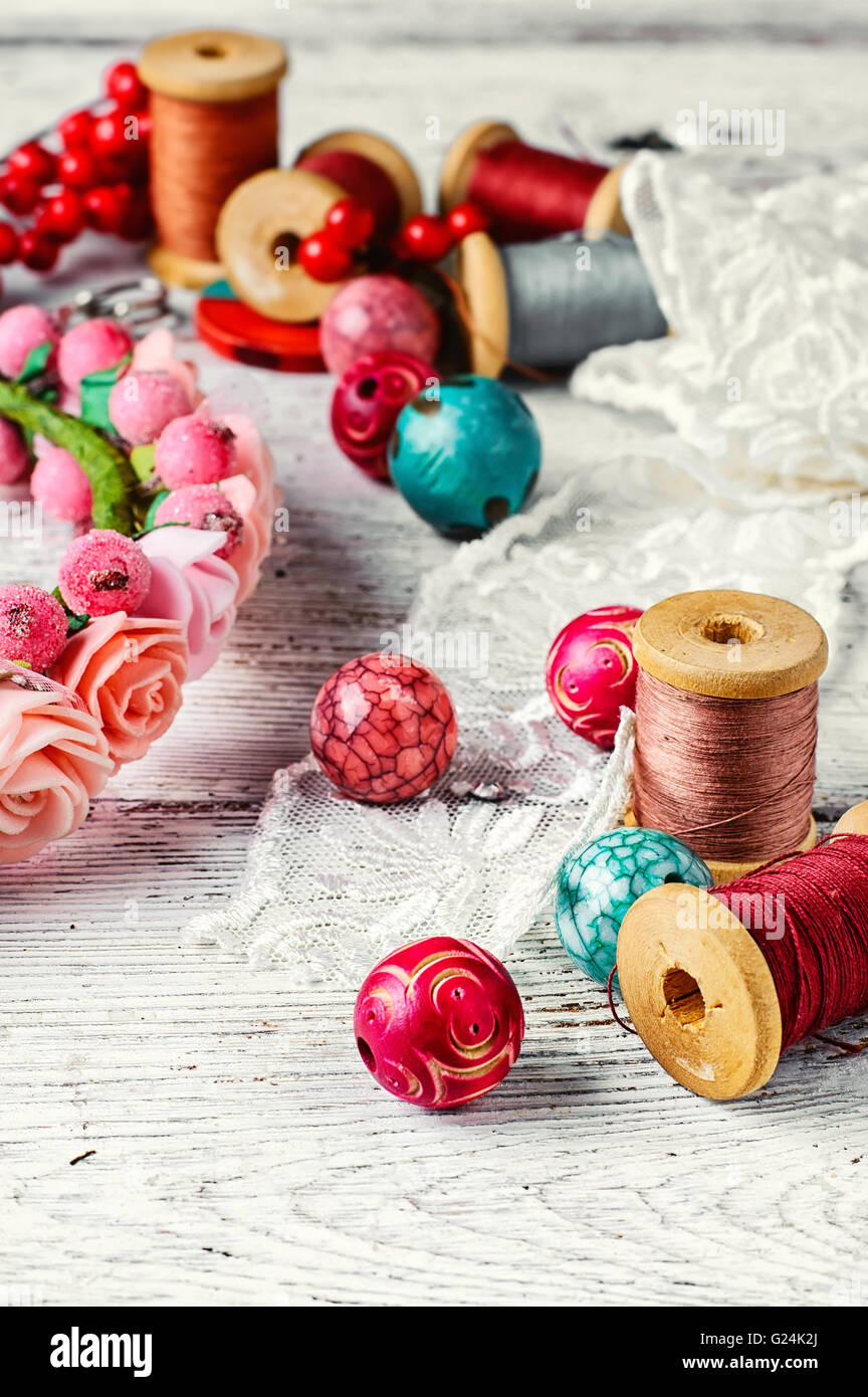White lace,sewing thread and charming wooden bead Stock Photo - Alamy