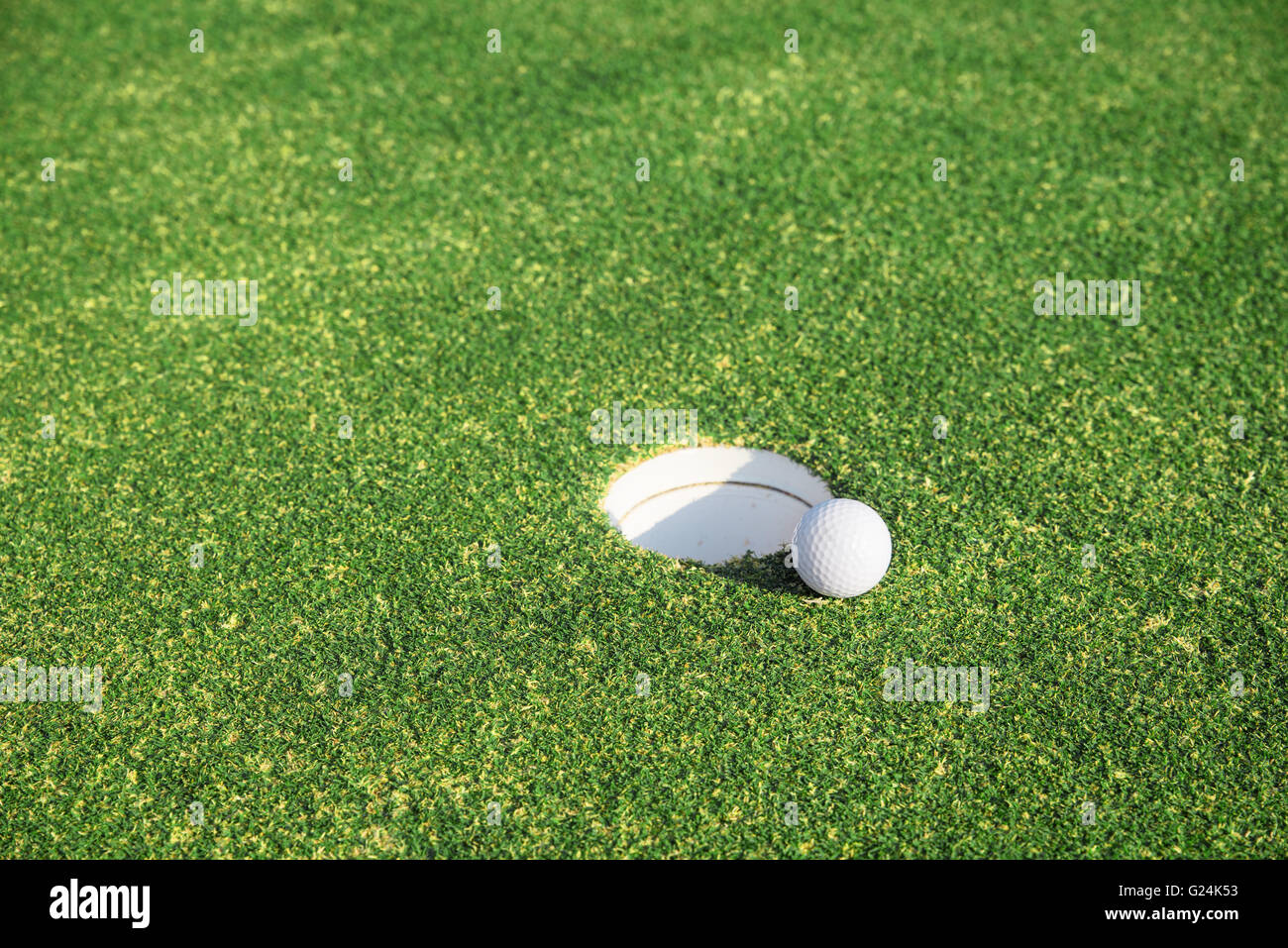 golf ball on lip of cup Stock Photo - Alamy