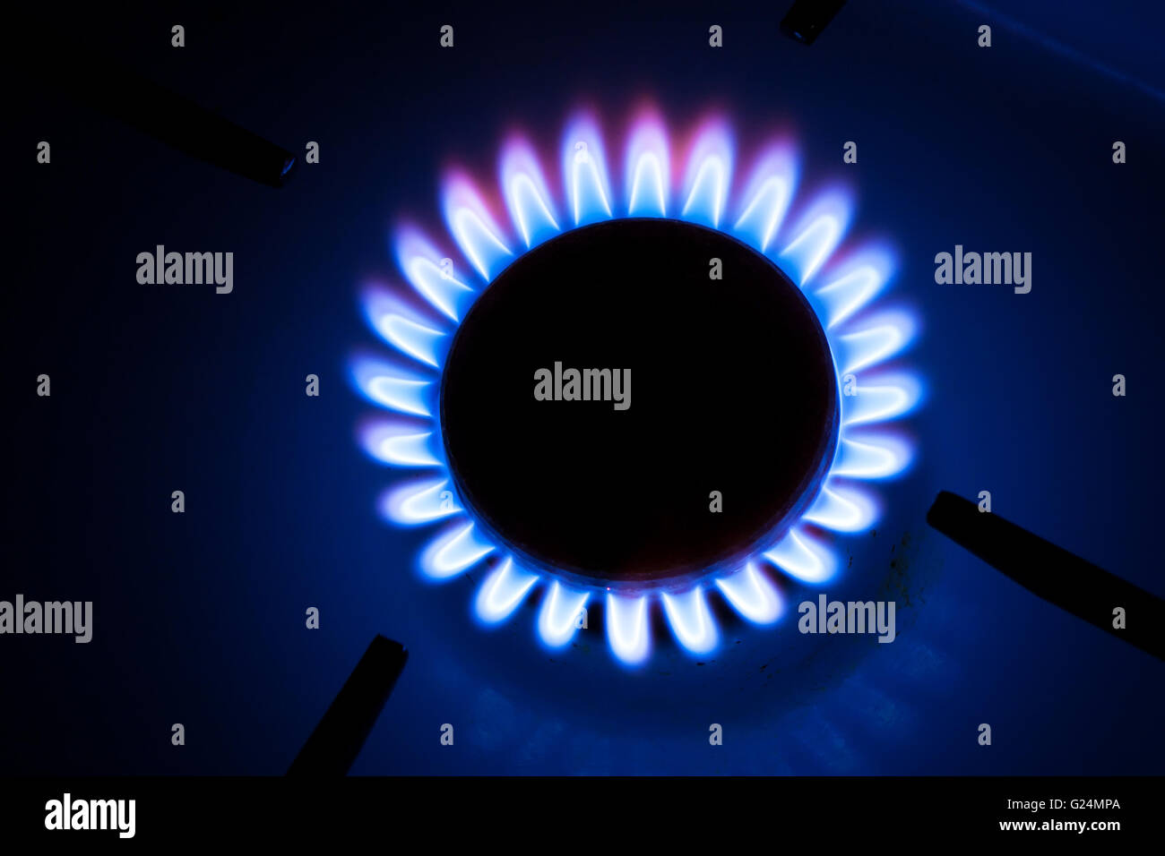 Gas burning by a dark blue flame on kitchen Stock Photo - Alamy