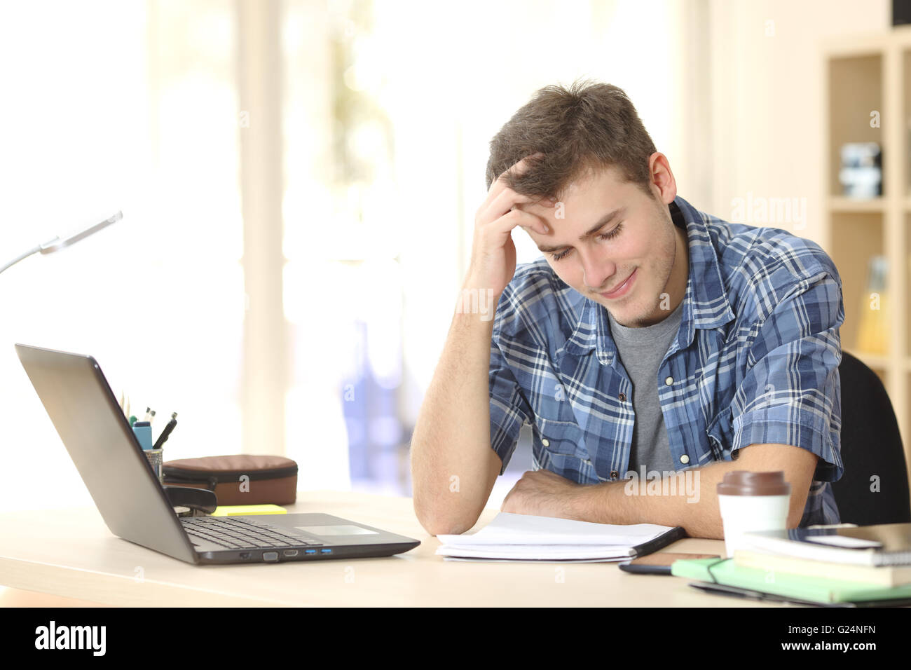 Student studying and learning reading notes on a desktop in his room at ...