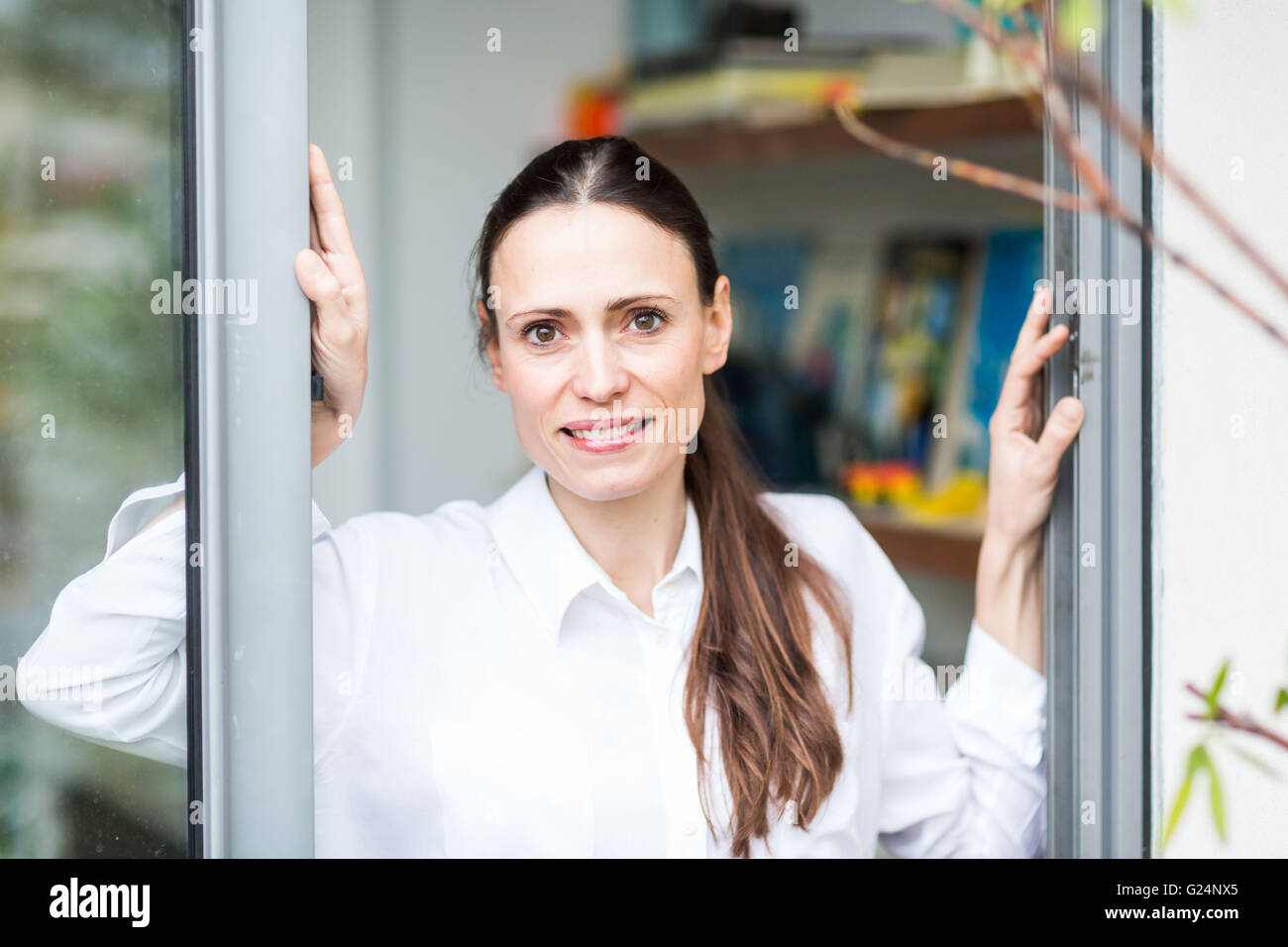 Woman opening window Stock Photo - Alamy