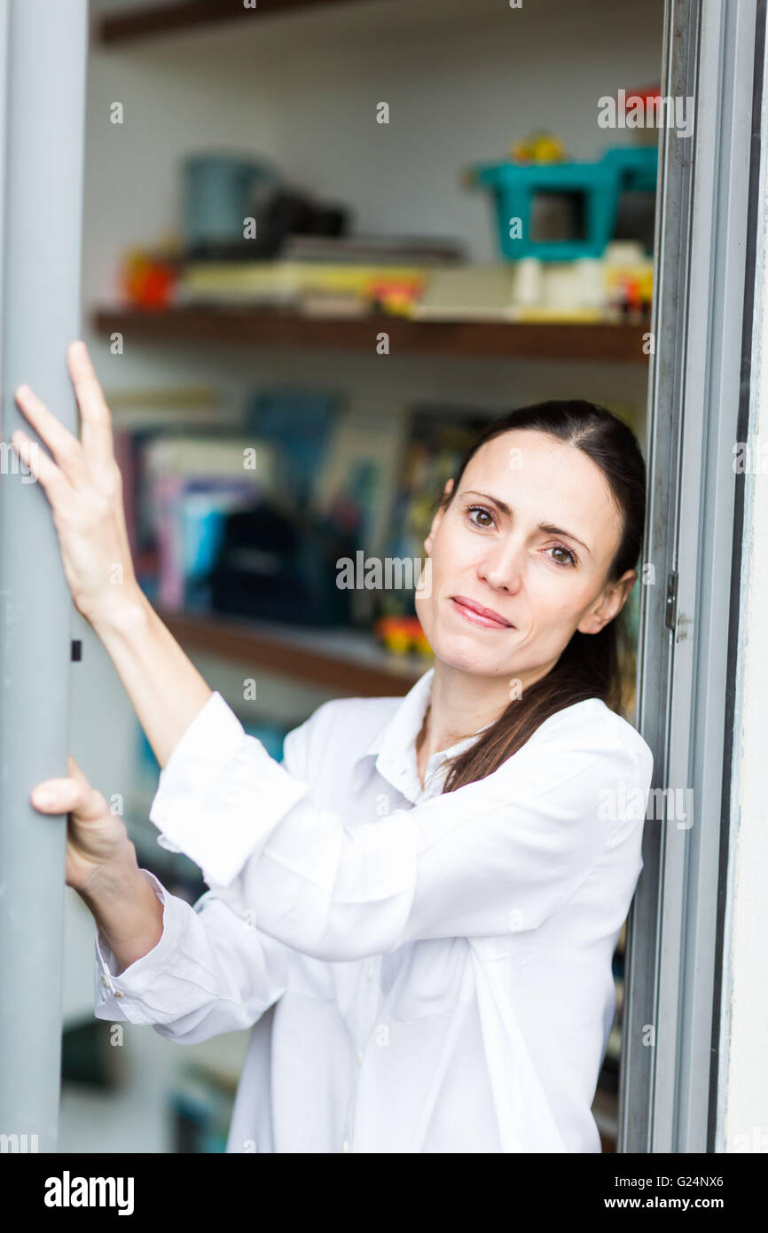Woman opening window Stock Photo - Alamy