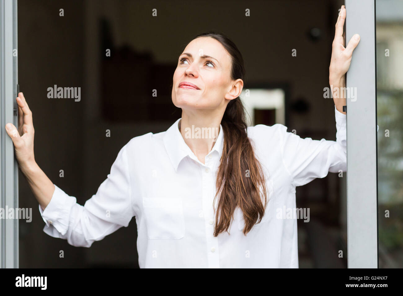 Woman opening window Stock Photo - Alamy